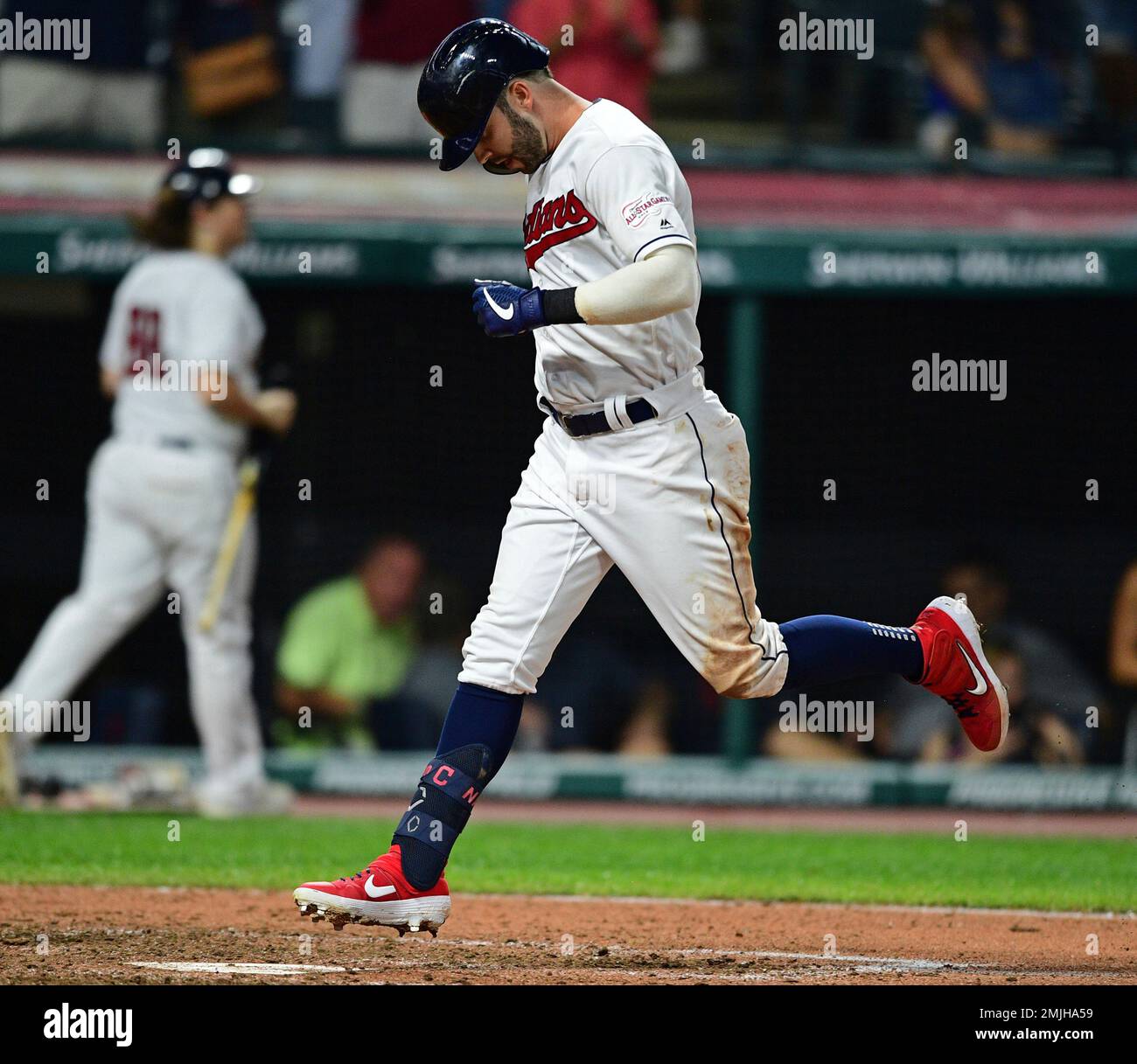 Cleveland Indians' Tyler Naquin steps on home plate after hitting a ...