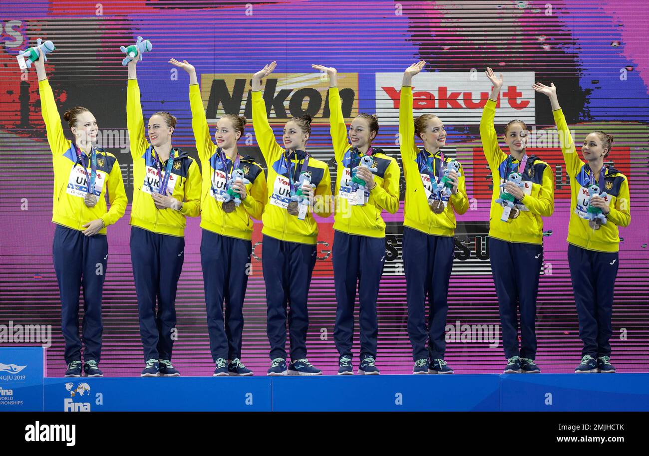 Ukraine wave on the podium after receiving their bronze medals in the ...
