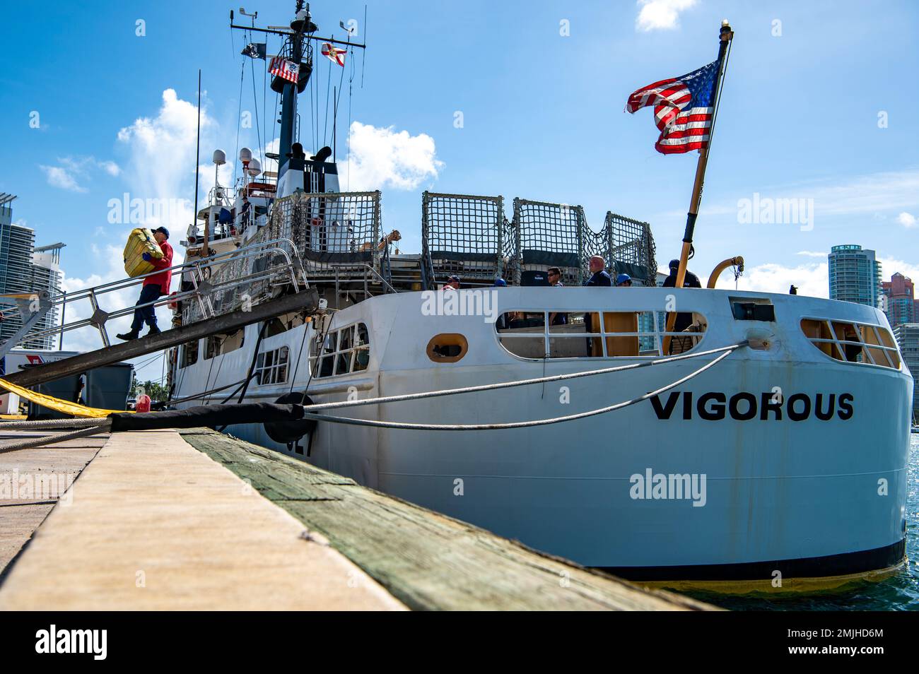 The crew of the U.S. Coast Guard Cutter Vigorous (WMEC 627) offloads ...