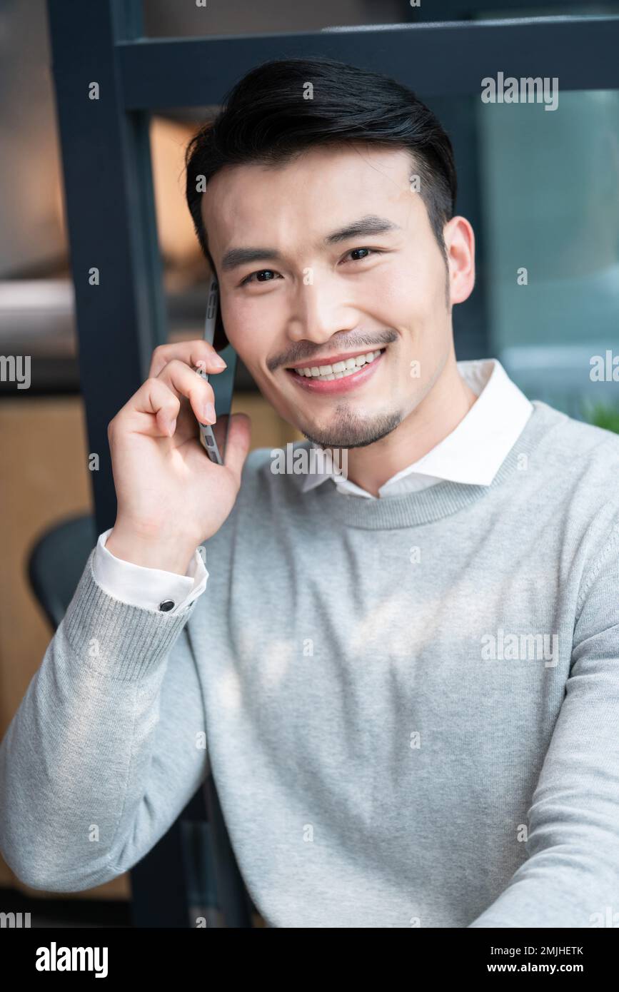Young men who use mobile phones Stock Photo - Alamy