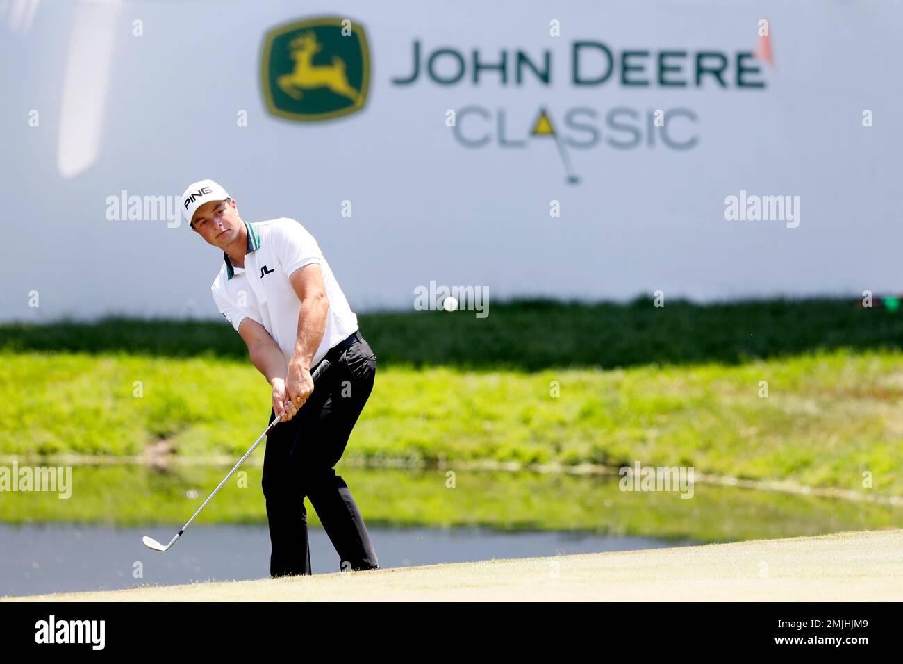 Viktor Hovland, of Norway, chips to the 18th green during the final round of the John Deere ...