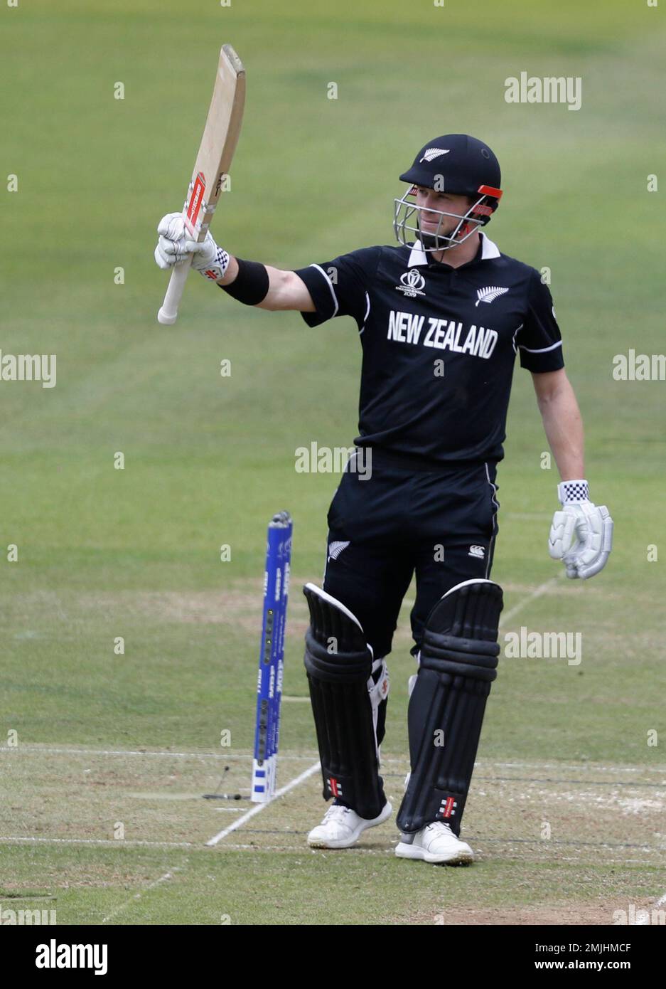 New Zealand's Henry Nicholls celebrates after getting 50 runs not out ...