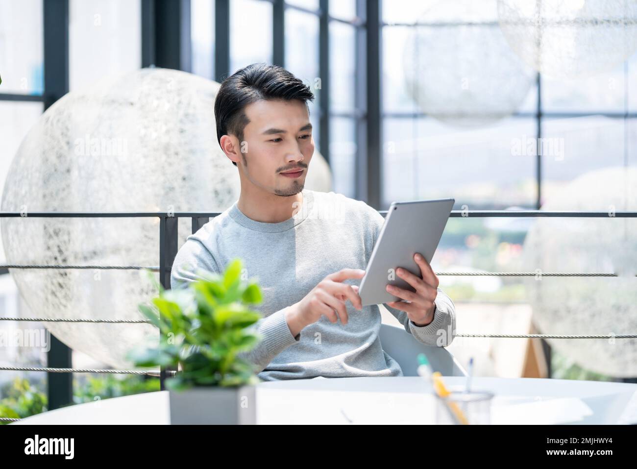The young man use tablets Stock Photo - Alamy
