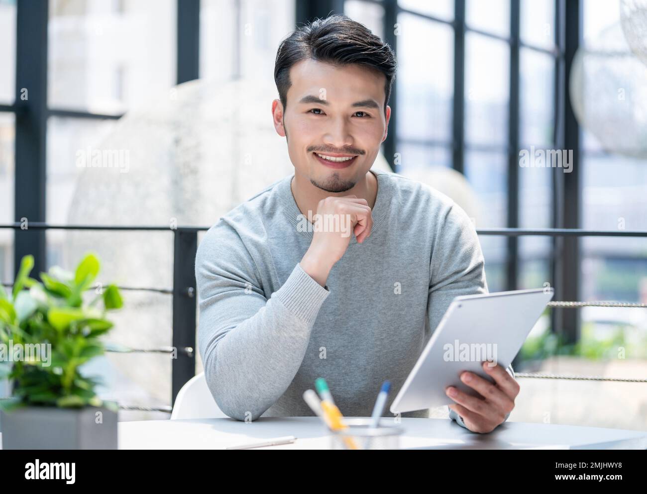 The young man use tablets Stock Photo - Alamy