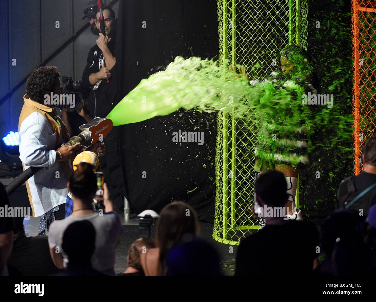 NFL player Russell Wilson, left, member of the Seattle Seahawks, sprays ...