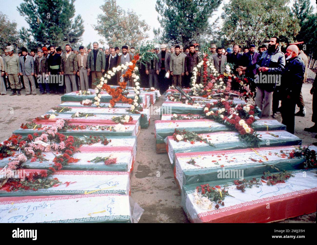 Iranian men assemble during the funerals of soldiers at the Cemetery of ...