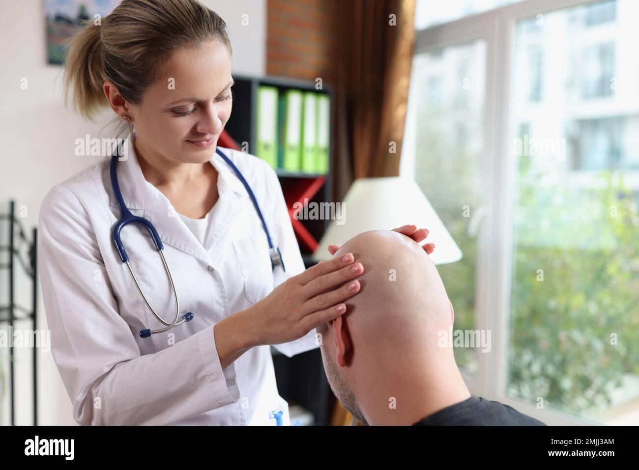 Female doctor examines male patient hi-res stock photography and images ...