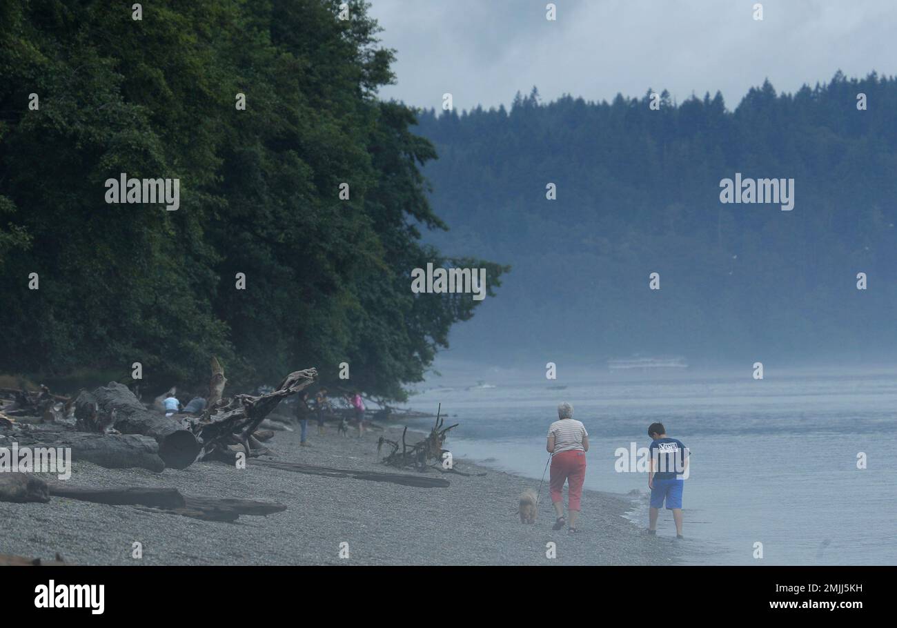 People walk along Owen Beach at Point Defiance Park, Wednesday, July 10 ...