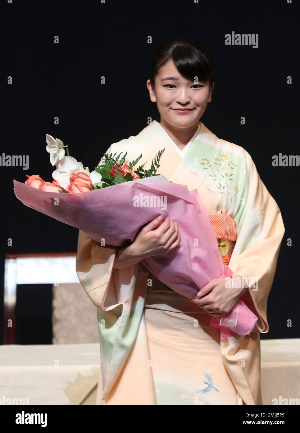 Japan's Princess Mako smiles as she holds a bouquet of flowers during a ...