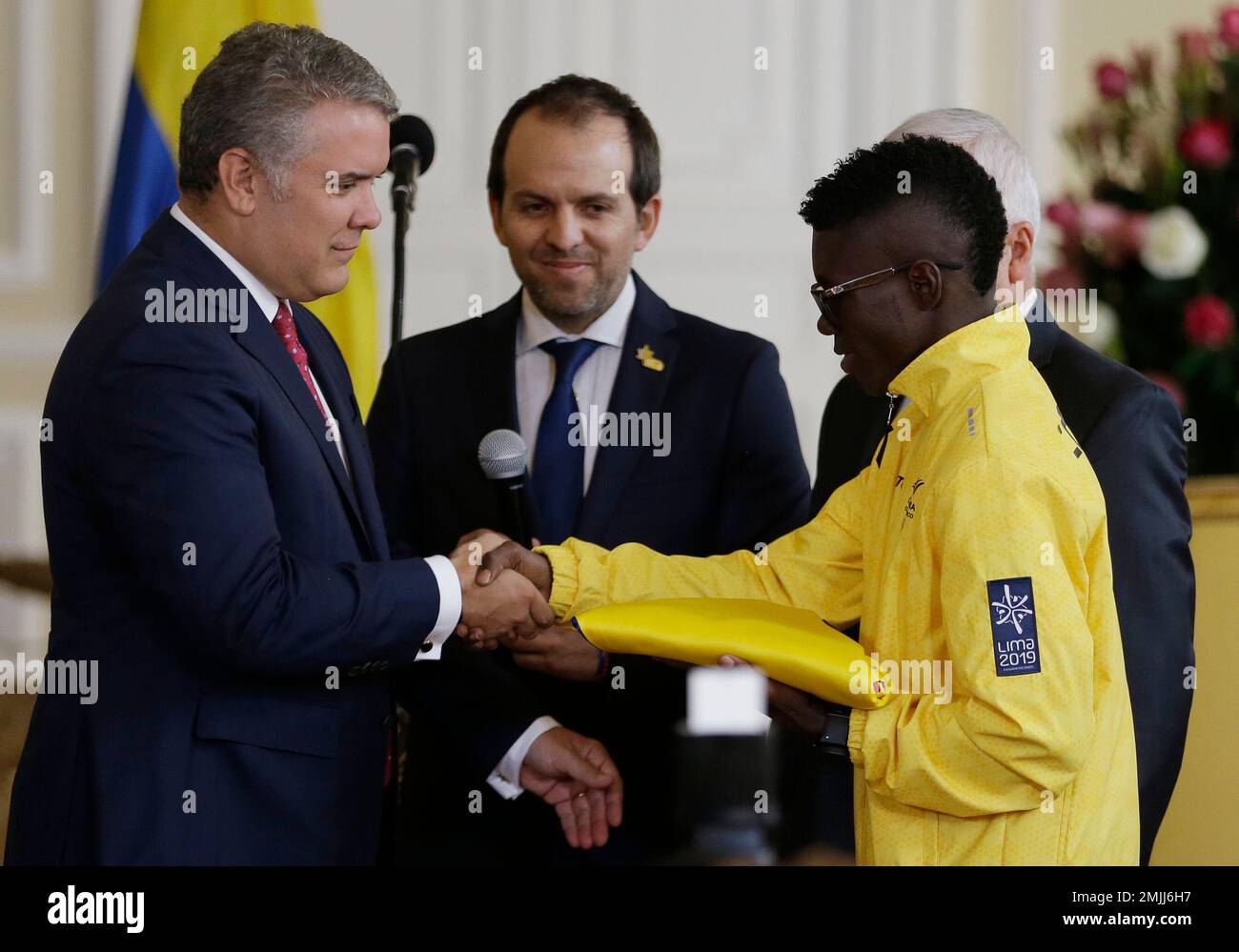Colombia's President Ivan Duque, left, shakes hands with Colombian ...
