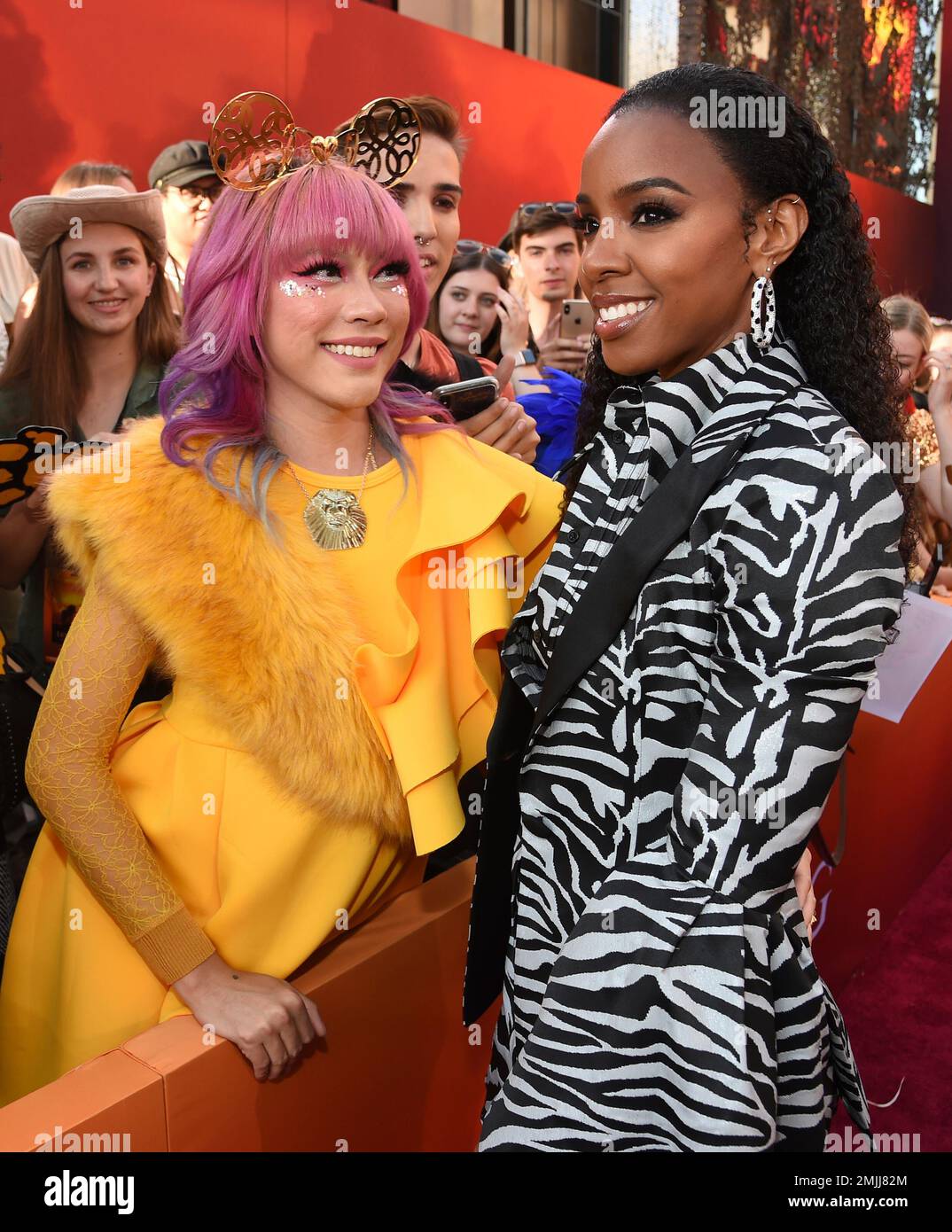 Kelly Rowland, right, greets a fan as she arrives at the world premiere ...