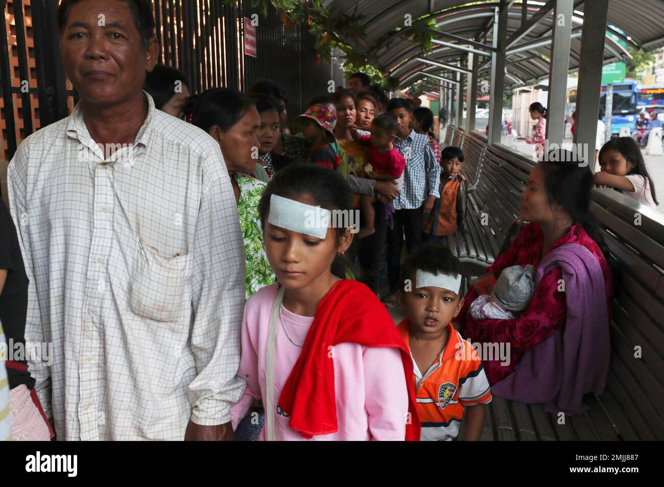 Villagers line up for a medical check-up for their children outside the Kuntha Bopha children's ...