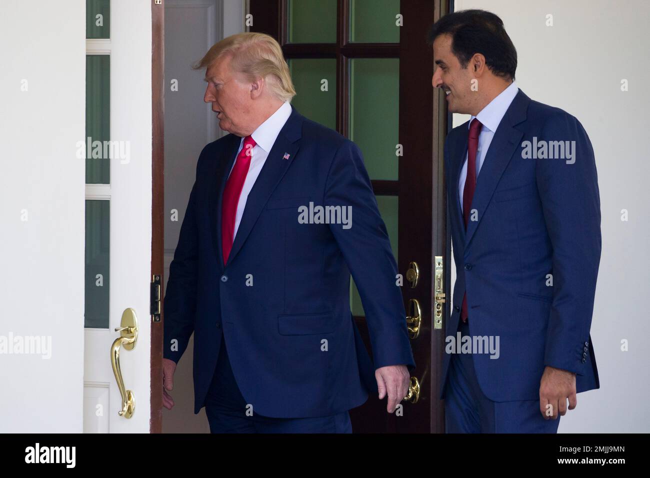 President Donald Trump heads inside followed by Qatar's Emir Sheikh Tamim bin Hamad Al Thani ...