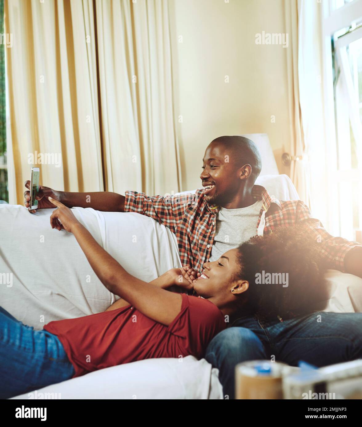 Weekends are best when theyre together. a young couple relaxing ...