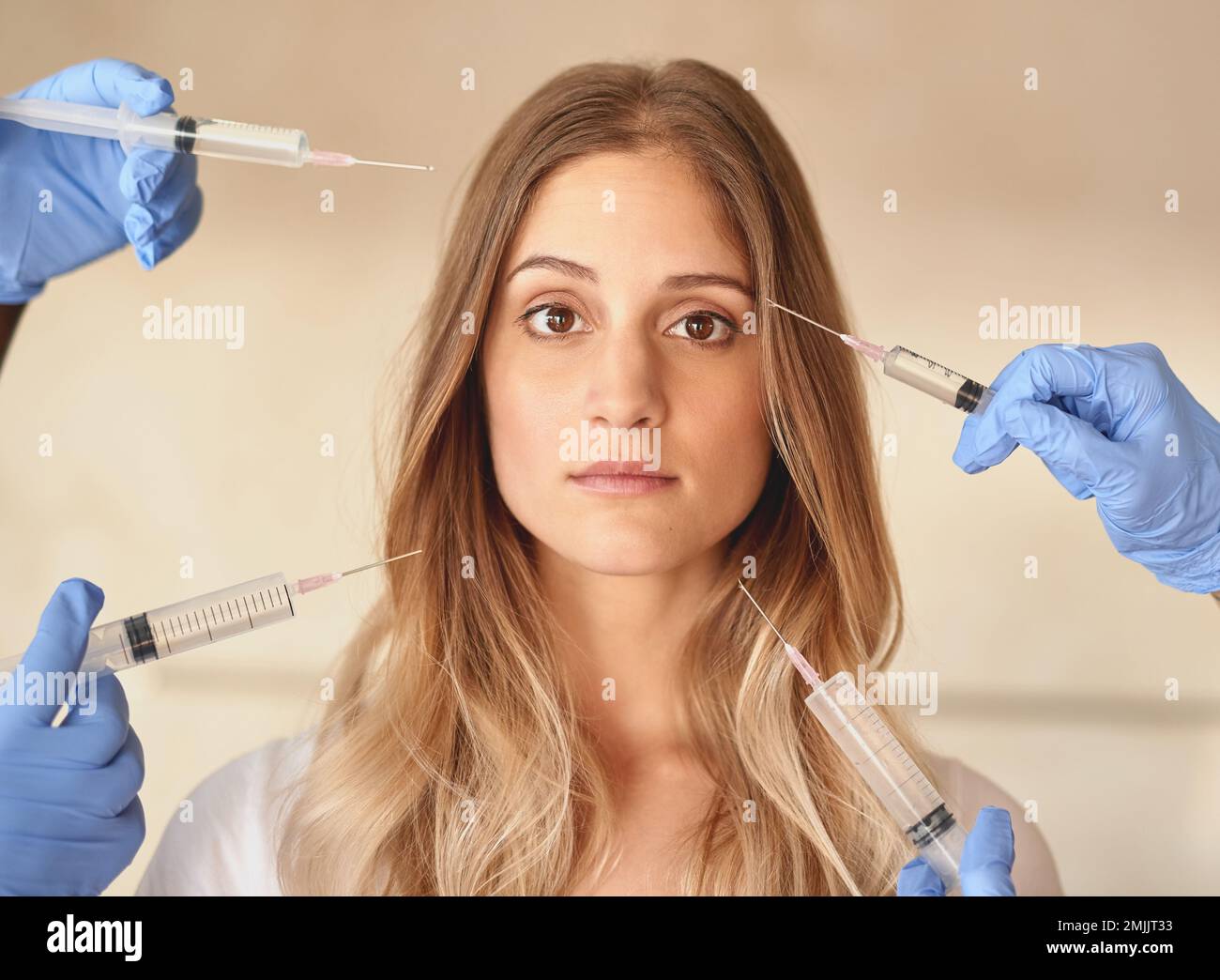 Lets win this anti-aging battle. Portrait of a young woman with needles ...