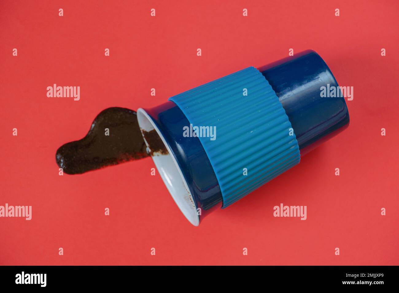 cup lies on a red background with spilled coffee Stock Photo - Alamy