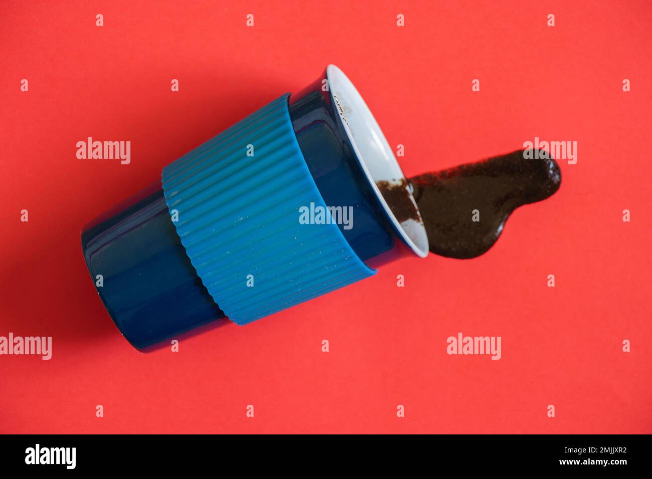 cup lies on a red background with spilled coffee Stock Photo - Alamy
