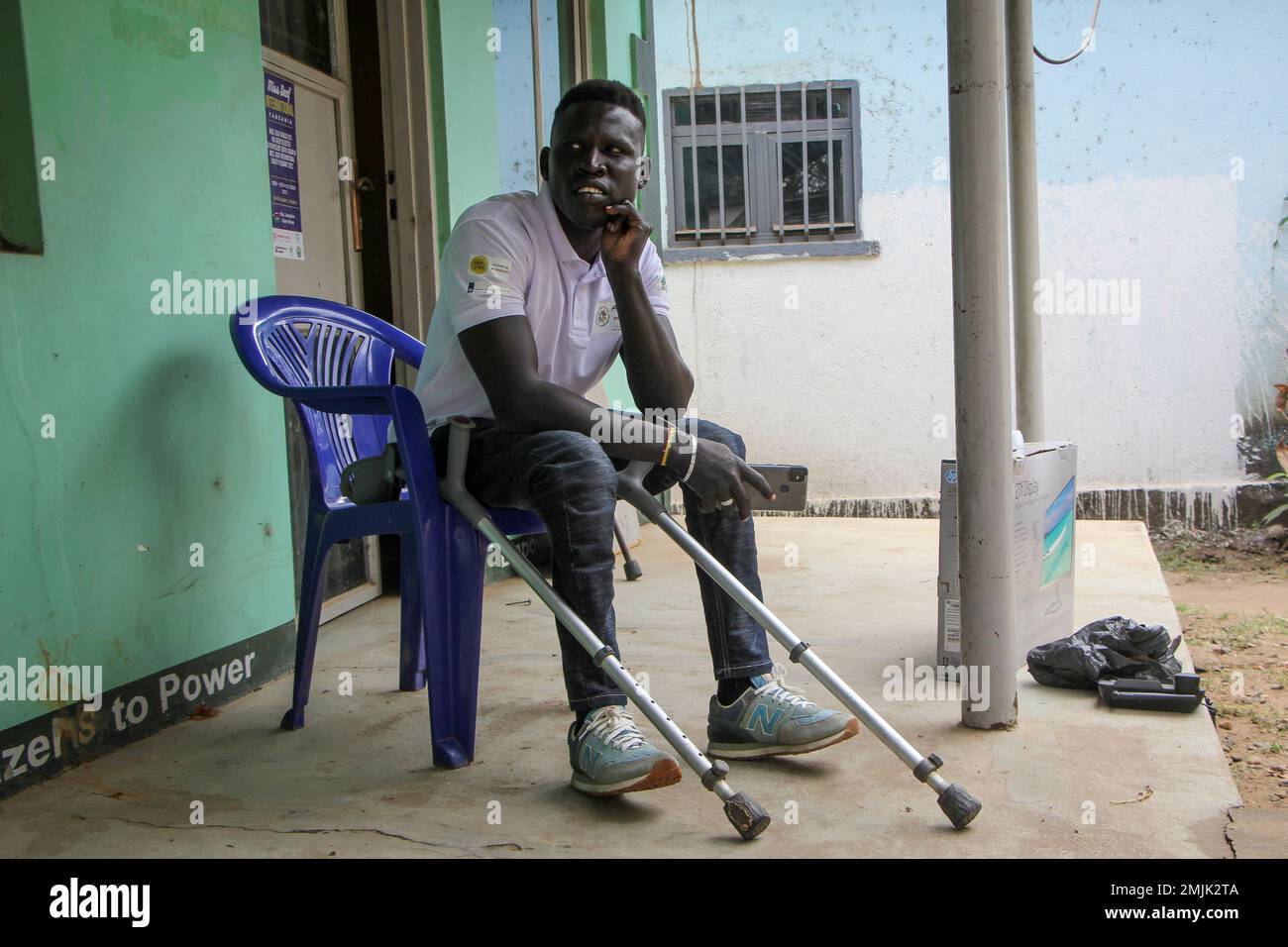 Wheelchair user Seme Lado Michael sits outside his office in Juba ...