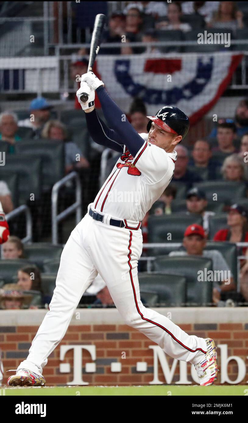 Atlanta Braves first baseman Freddie Freeman follows through on a home ...