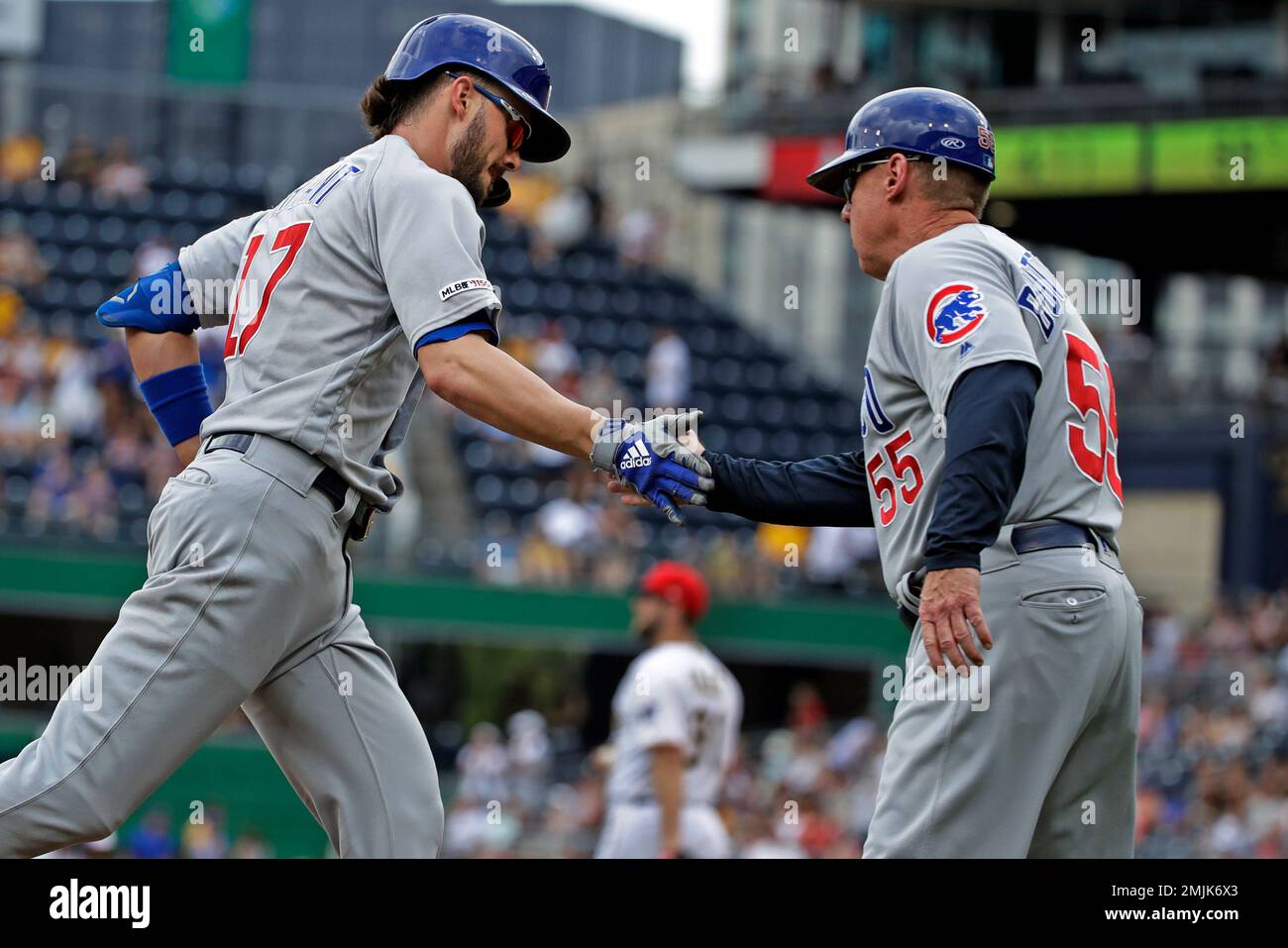 Chicago Cubs' Kris Bryant, left, rounds third to greetings from third ...