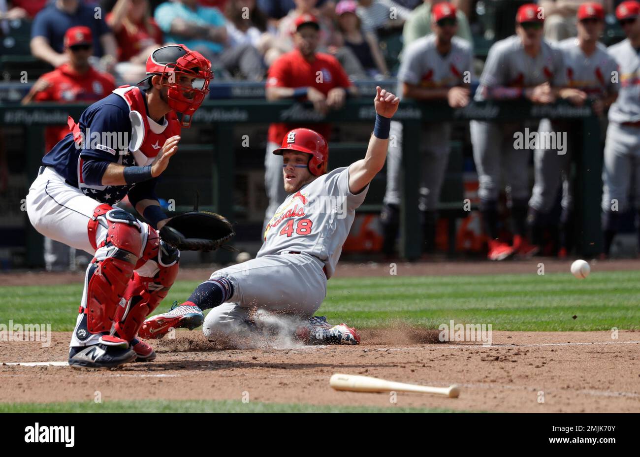 St. Louis Cardinals' Harrison Bader (48) scores ahead of the throw to ...