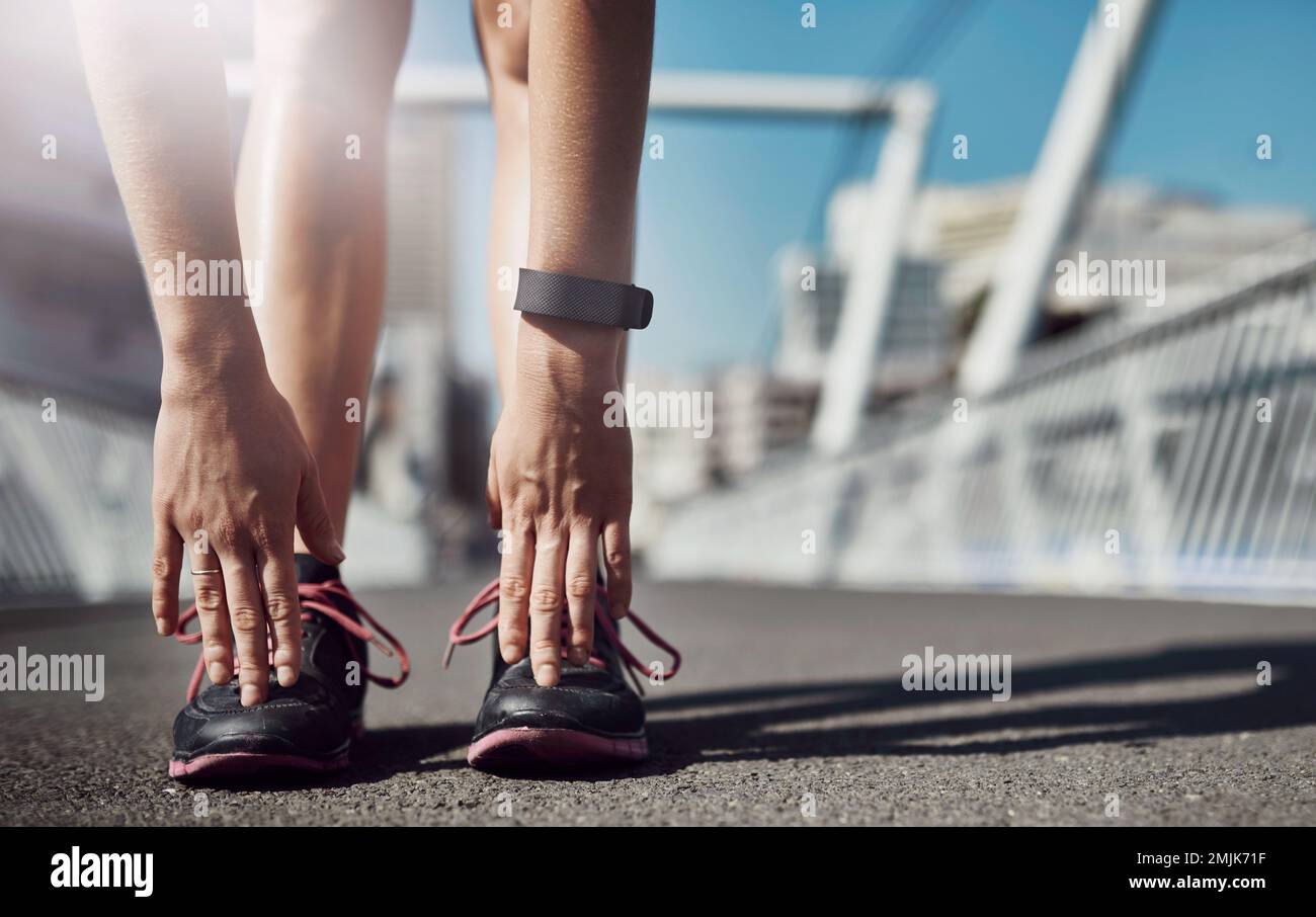 Hands to toes before you go. Legs-only shot of a sporty woman warming ...