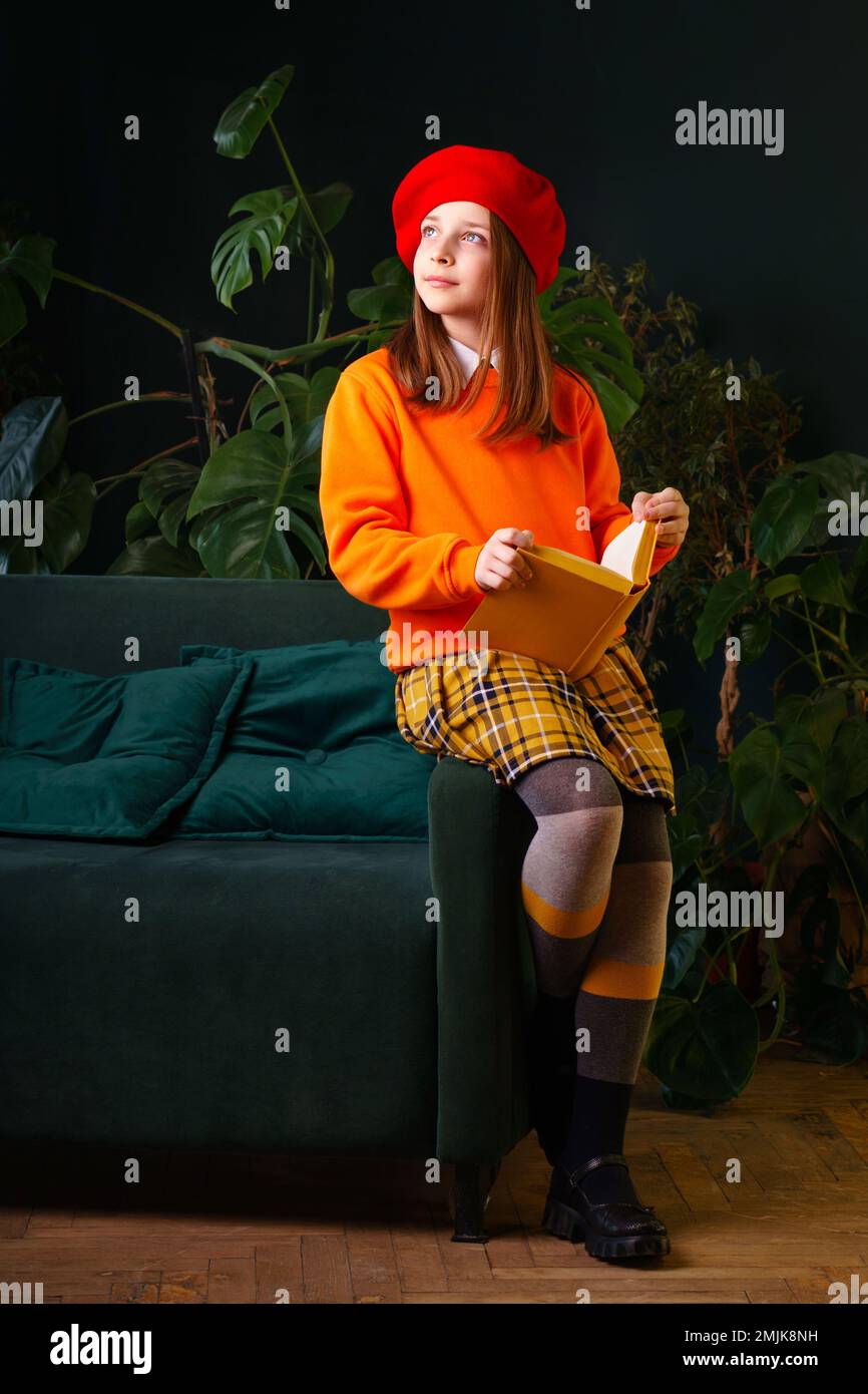 Full-length portrait young dreaming girl reading book. Concept of book ...