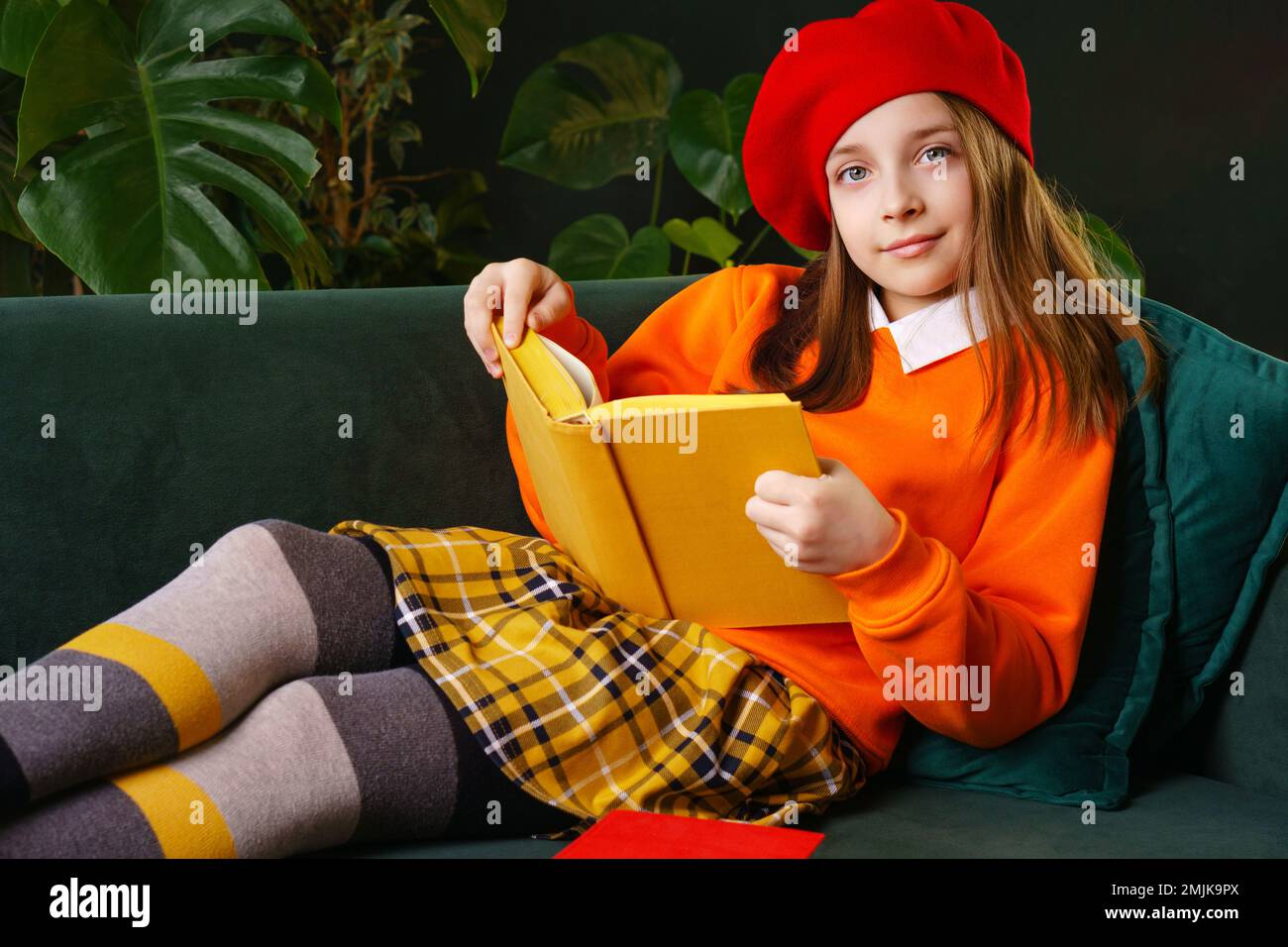 Portrait Schoolgirl reads book. Girl dressed in bright French-style ...