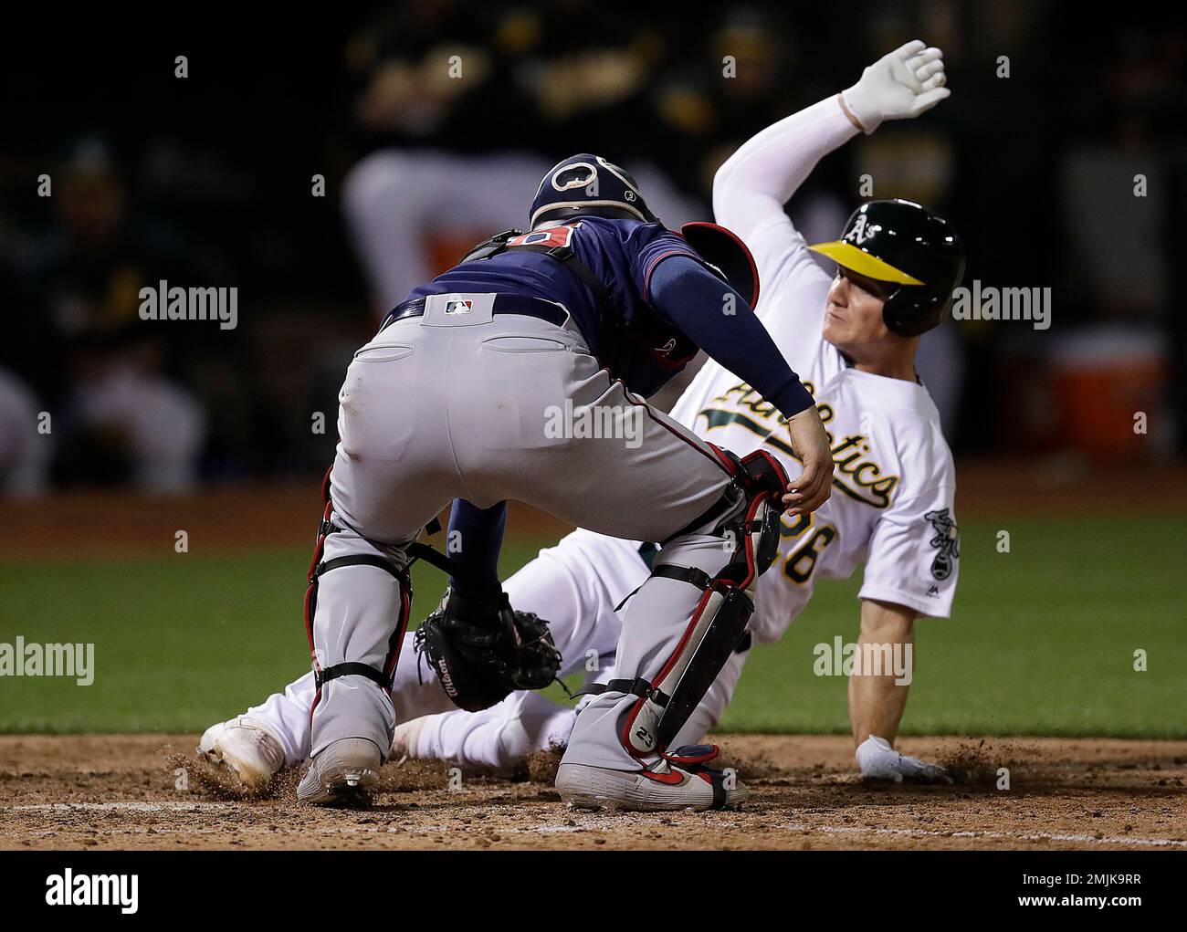 Minnesota Twins' Mitch Garver, left, tags out Oakland Athletics' Matt ...