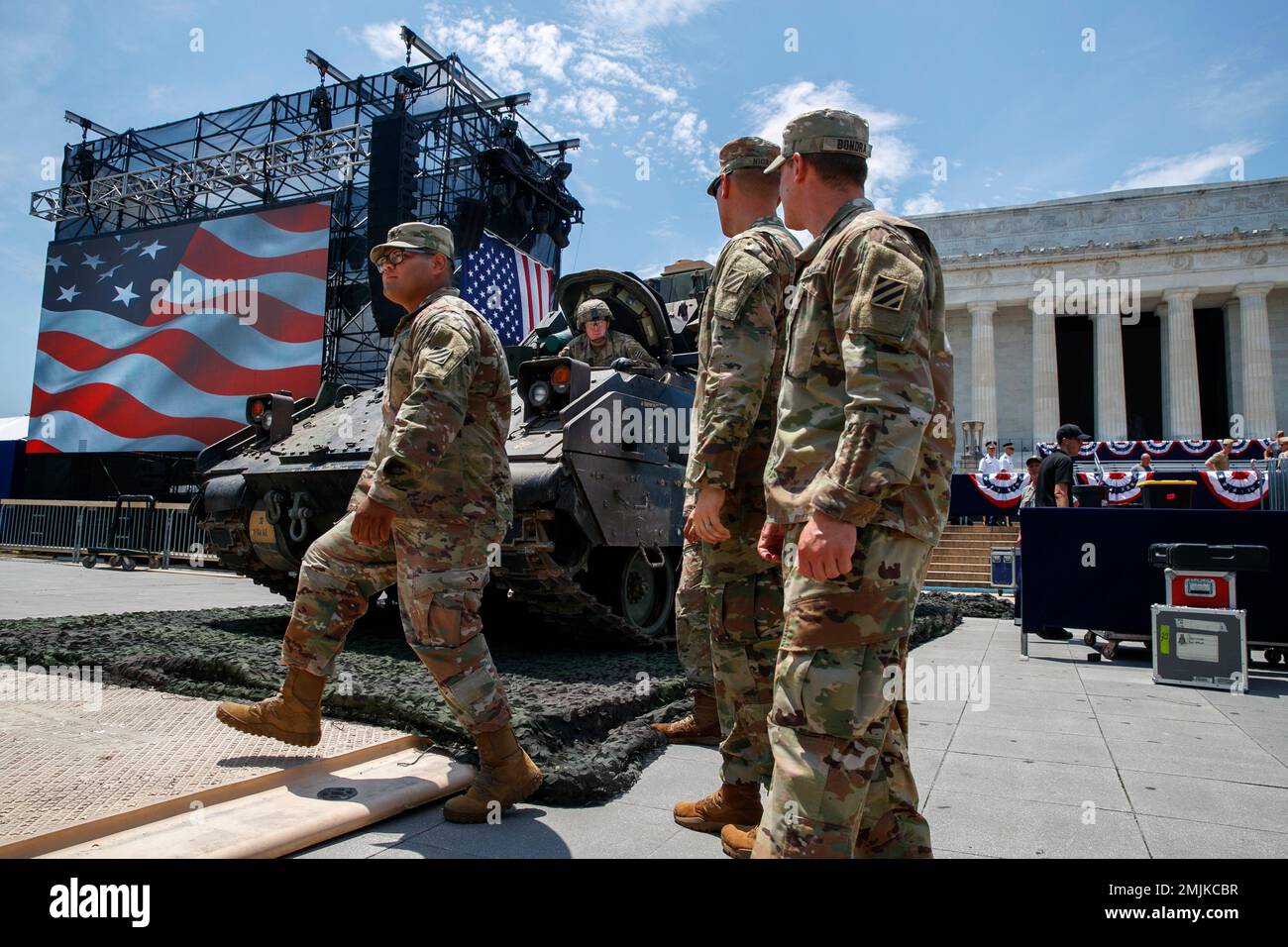 Army personnel manuever a Bradley Fighting Vehicle into place by the ...