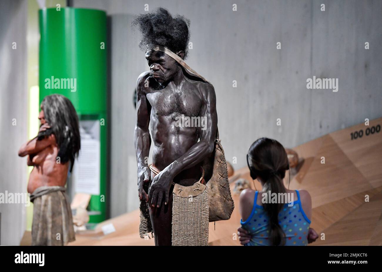 A little visitor watches the reconstruction of a 300,000 years old Homo ...
