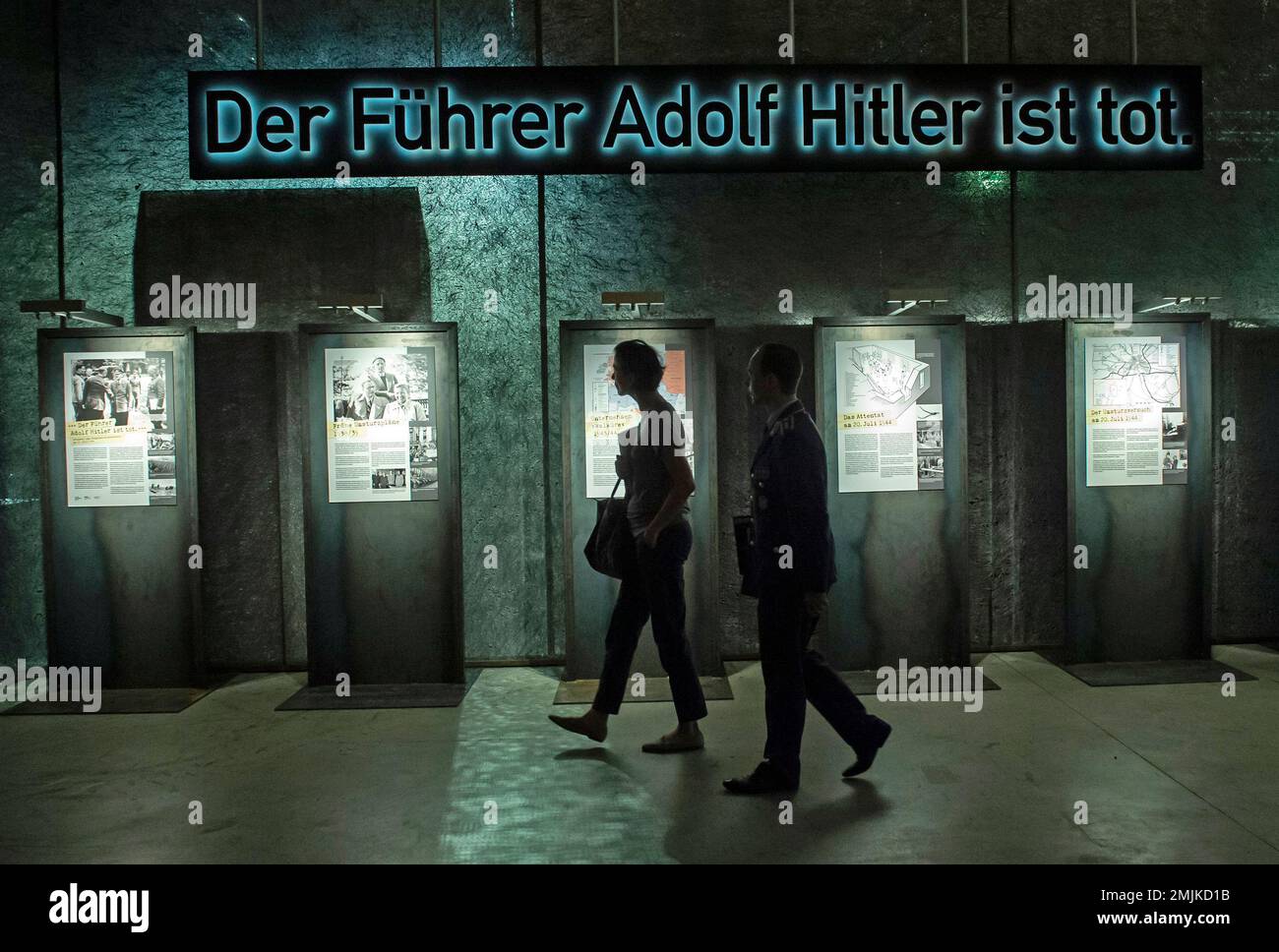 People walk in the exhibition room during a press preview of the ...