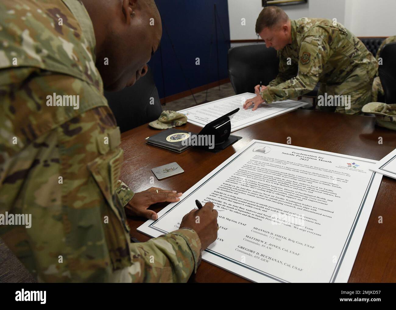 Col. Todd Randolph, 316th Wing and installation commander, signs a ...