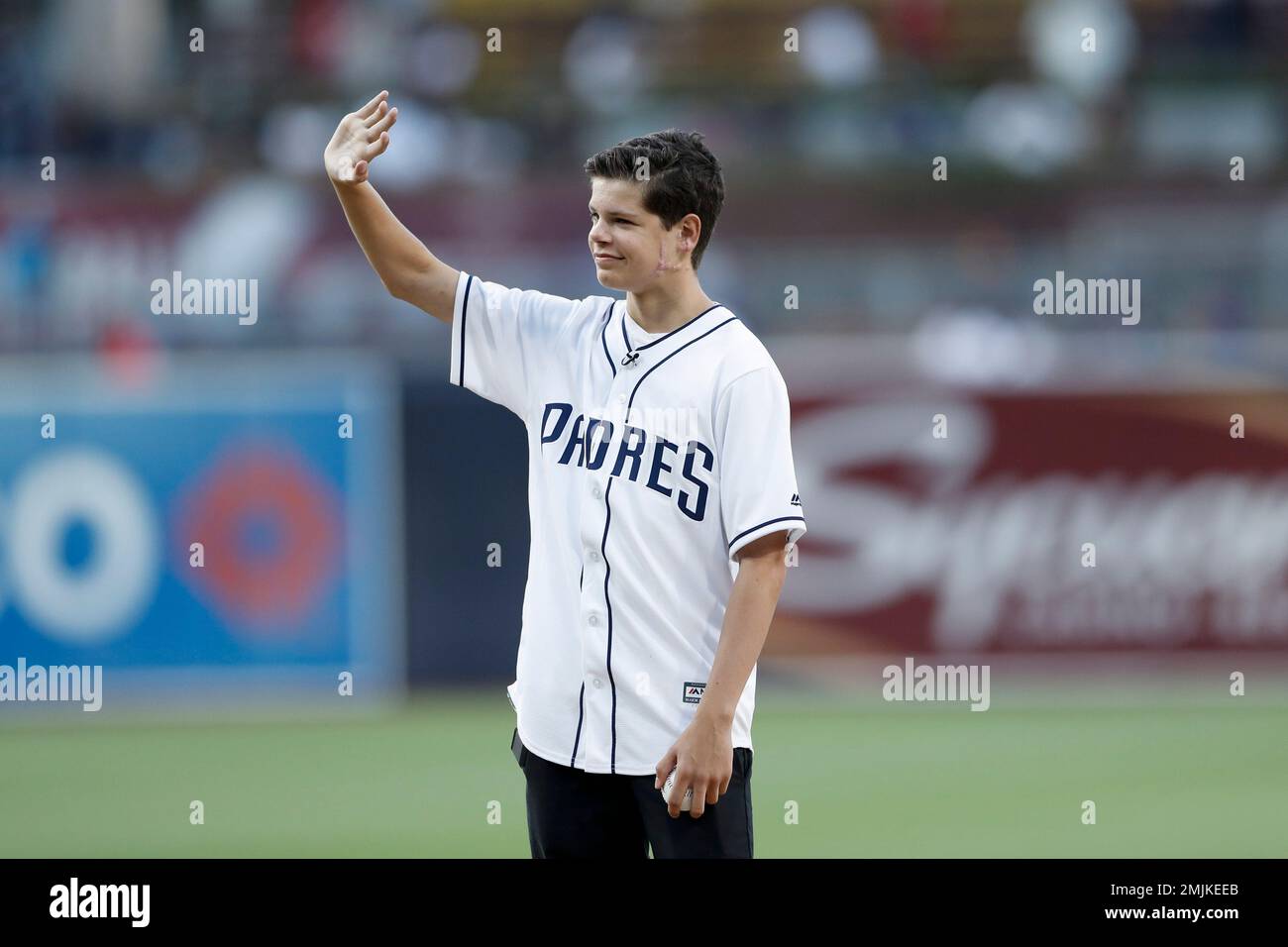 Keane Webre-Hayes waves before throwing a ceremonial first pitch before ...