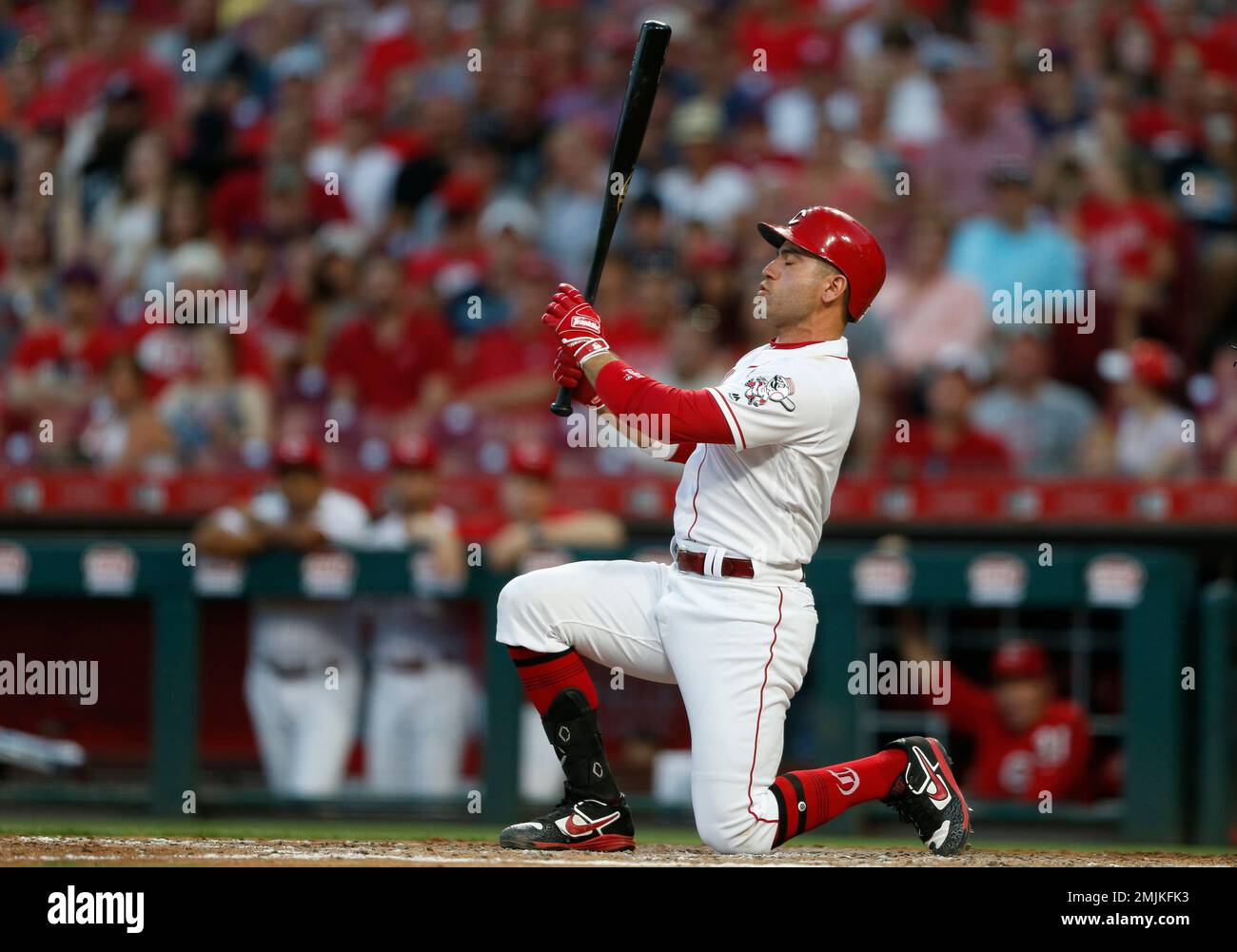 Cincinnati Reds' Joey Votto (19) hits his knee as he takes a ball for a ...