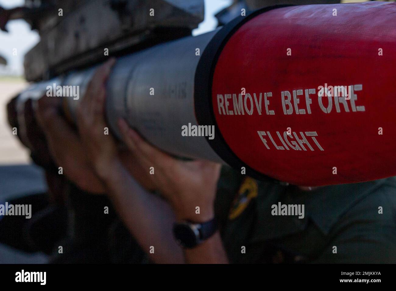 U.S. Marines with Marine Attack Squadron (VMA) 223 load an AIM-120A ...