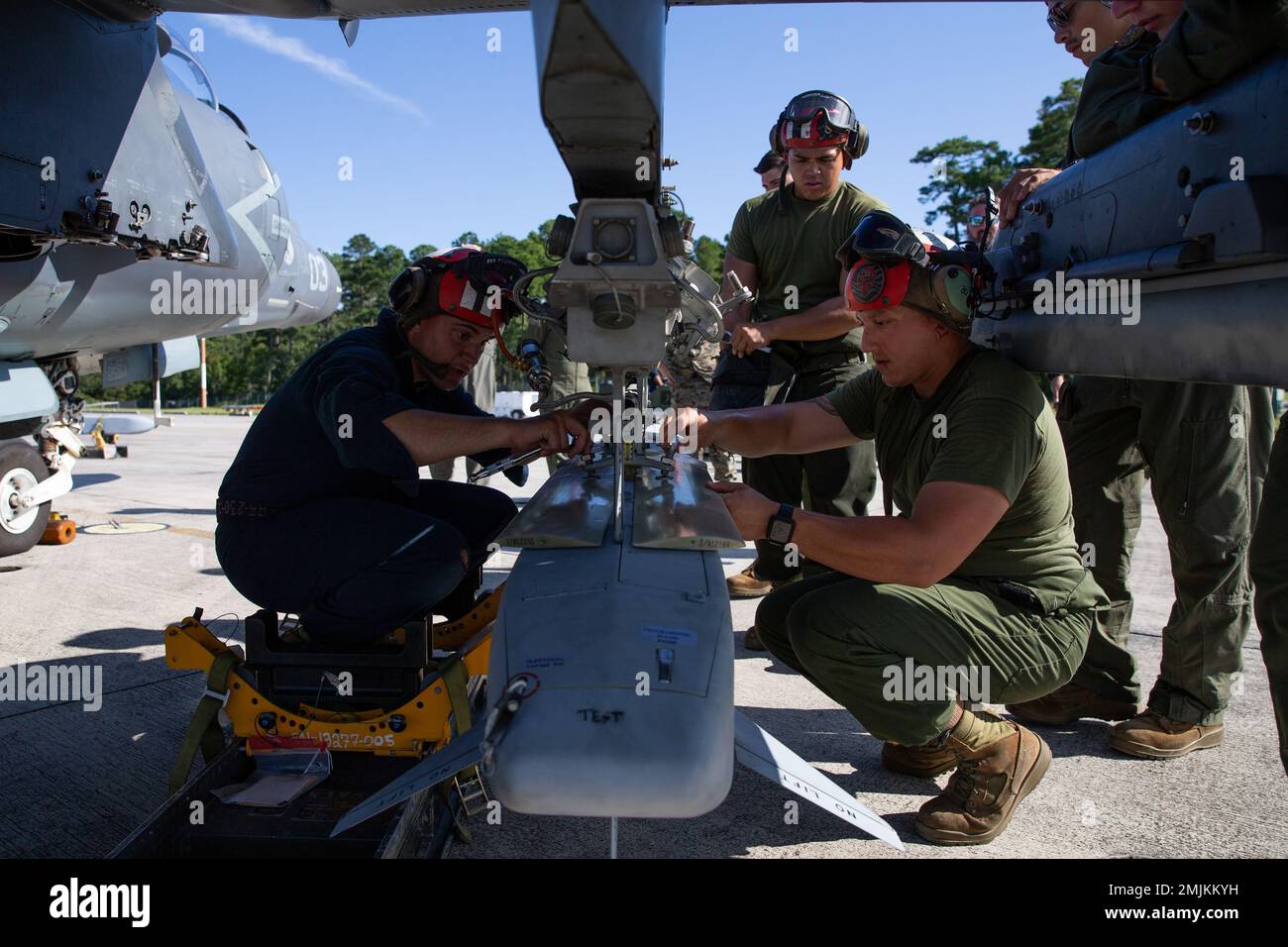 U.S. Marines with Marine Attack Squadron (VMA) 223 load an ADM-141A ...