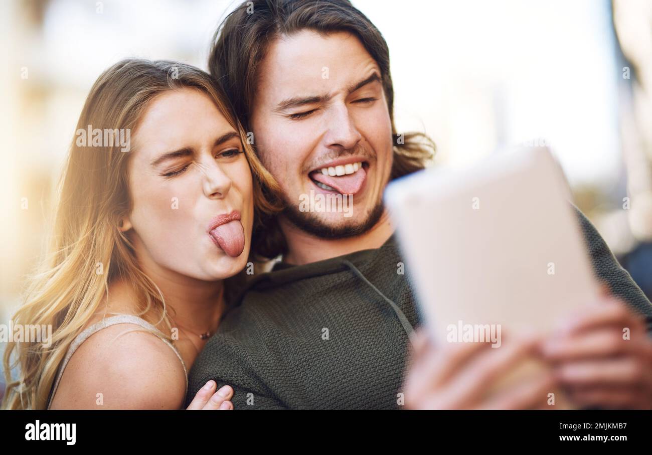 Were weird and we love it that way. Portrait of a young couple taking playful selfies together ...