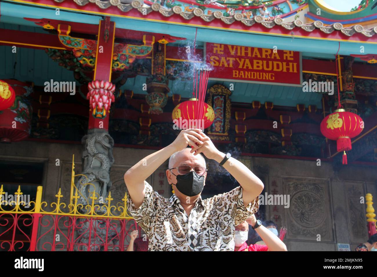 An old man worships in front of the Satya Budhi Temple in Bandung ...