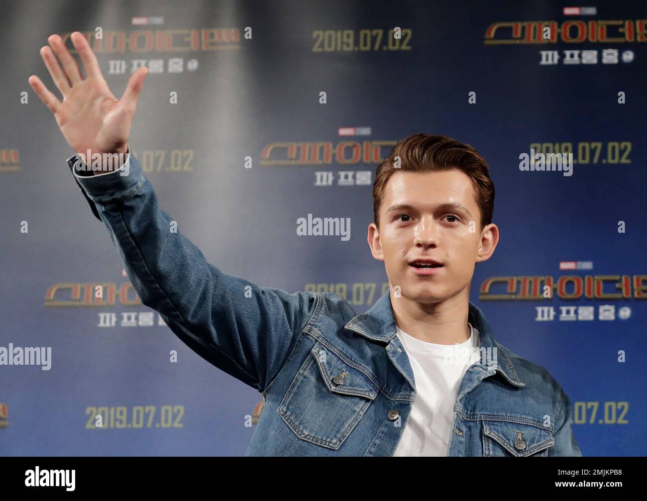 Actor Tom Holland Waves Upon His Arrival At A Press Conference For His
