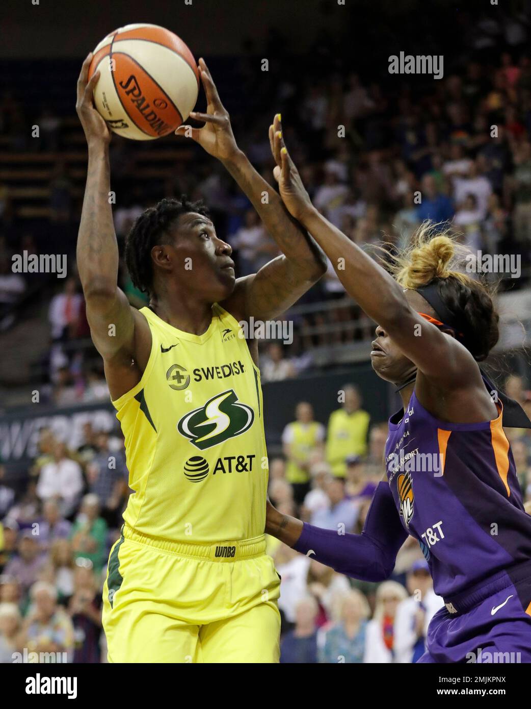 Seattle Storm's Natasha Howard, left, tries to shoot past Phoenix ...