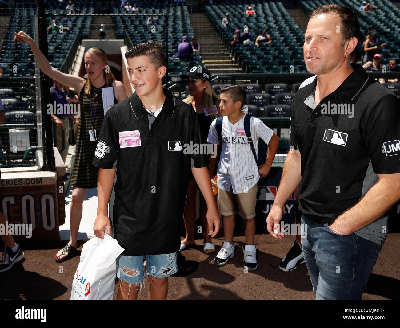 Josh Cordove, left, a 13-year-old baseball umpire from Denver, joins ...
