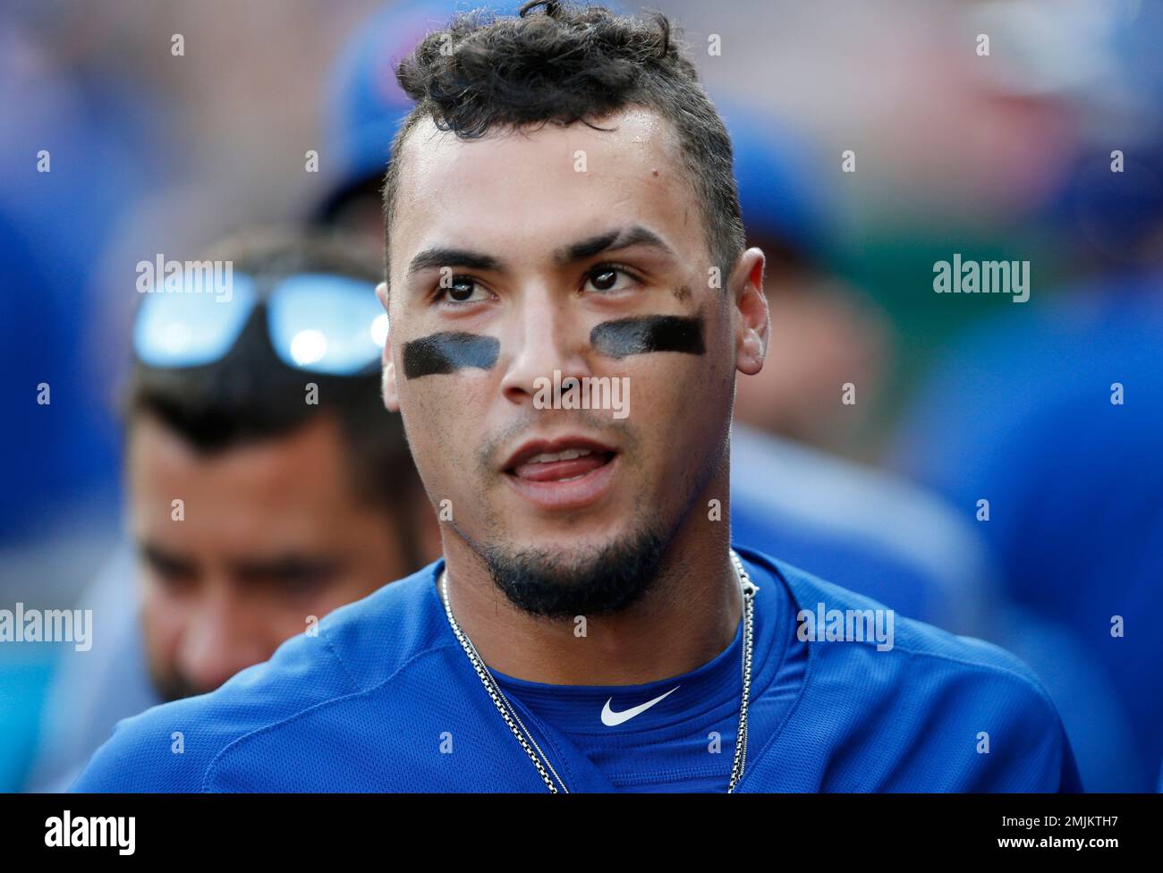 Chicago Cubs' Javier Baez reacts in the dugout after hitting a grand ...