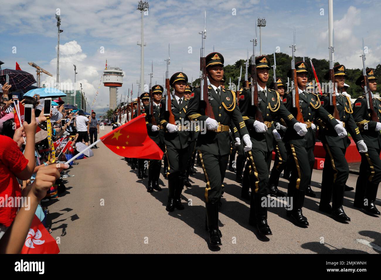 Chinese People's Liberation Army (PLA) soldiers take part in a flag ...