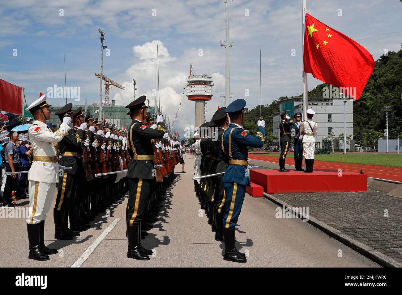Chinese People's Liberation Army (PLA) soldiers take part in a flag ...