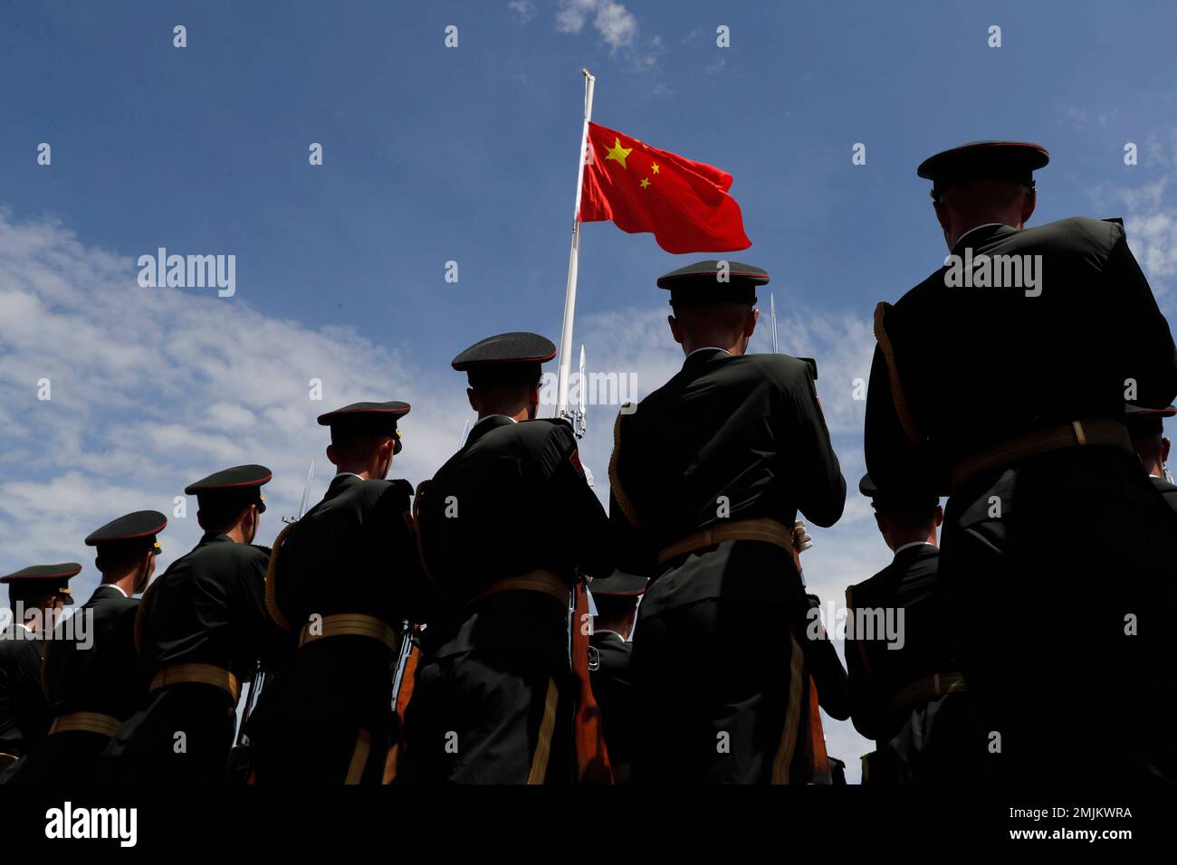 Chinese People's Liberation Army (PLA) soldiers take part in a flag ...