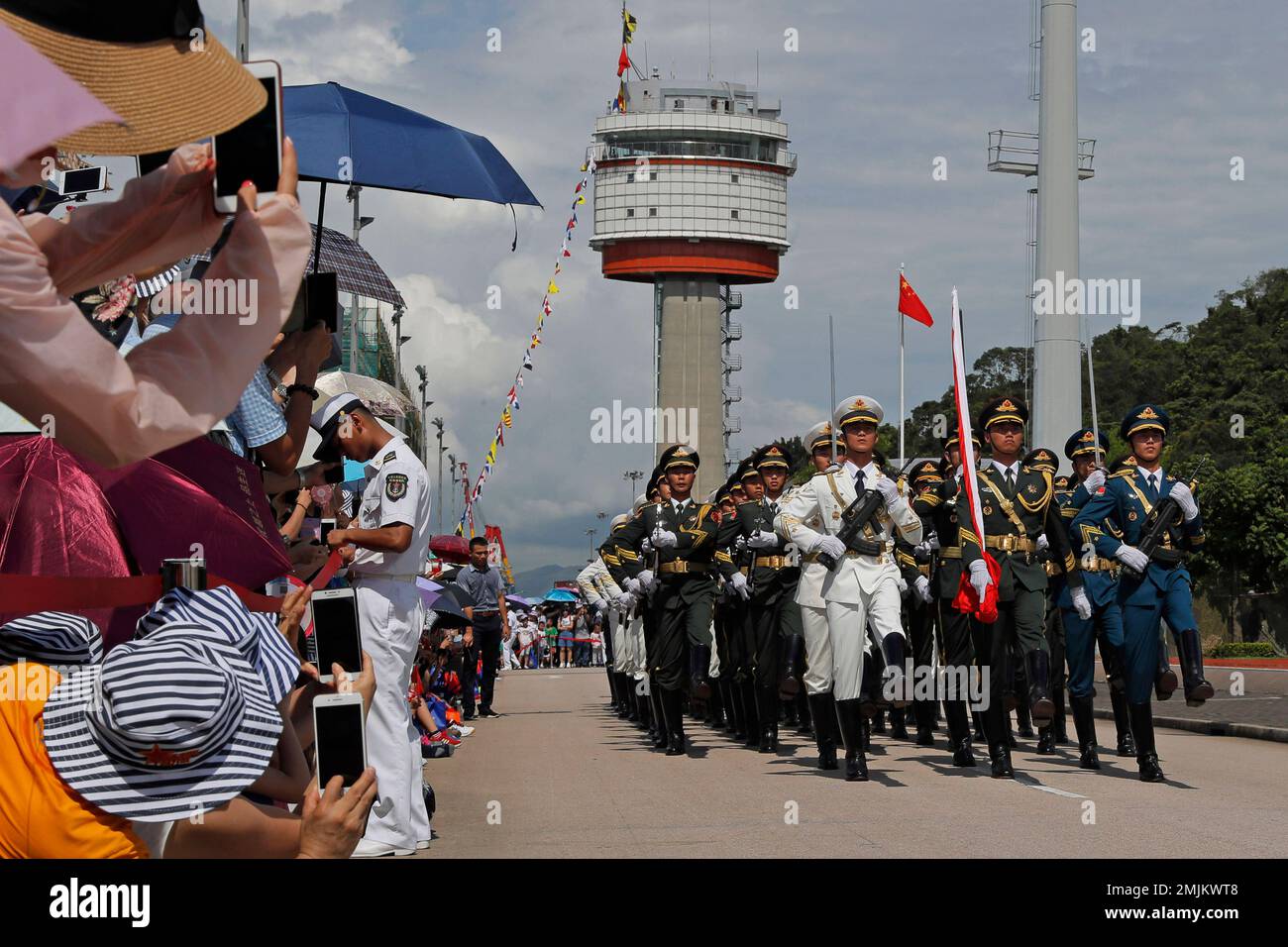 Chinese People's Liberation Army (PLA) soldiers take part in a flag ...