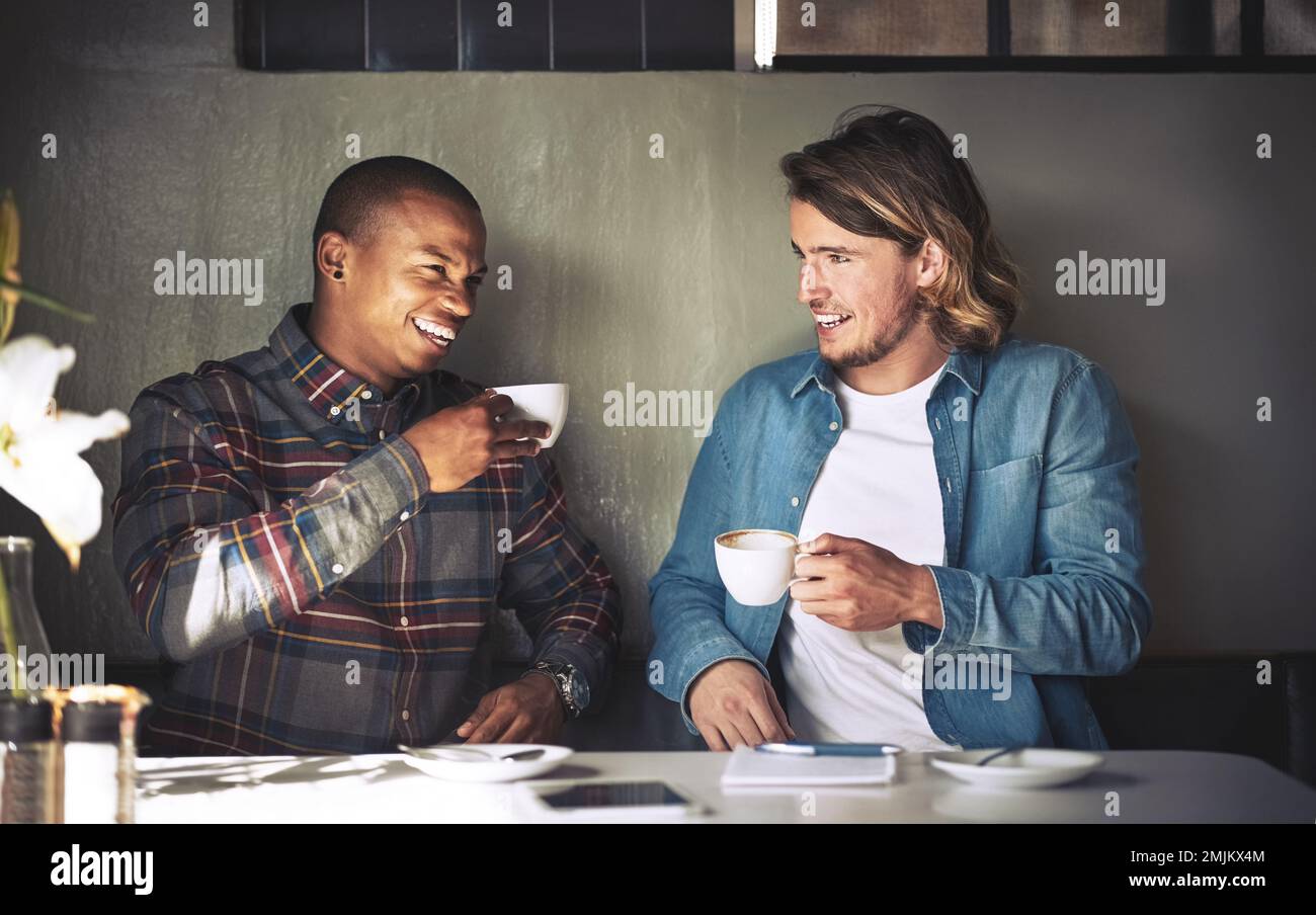 At their favorite coffee place. two friends having coffee together in a ...