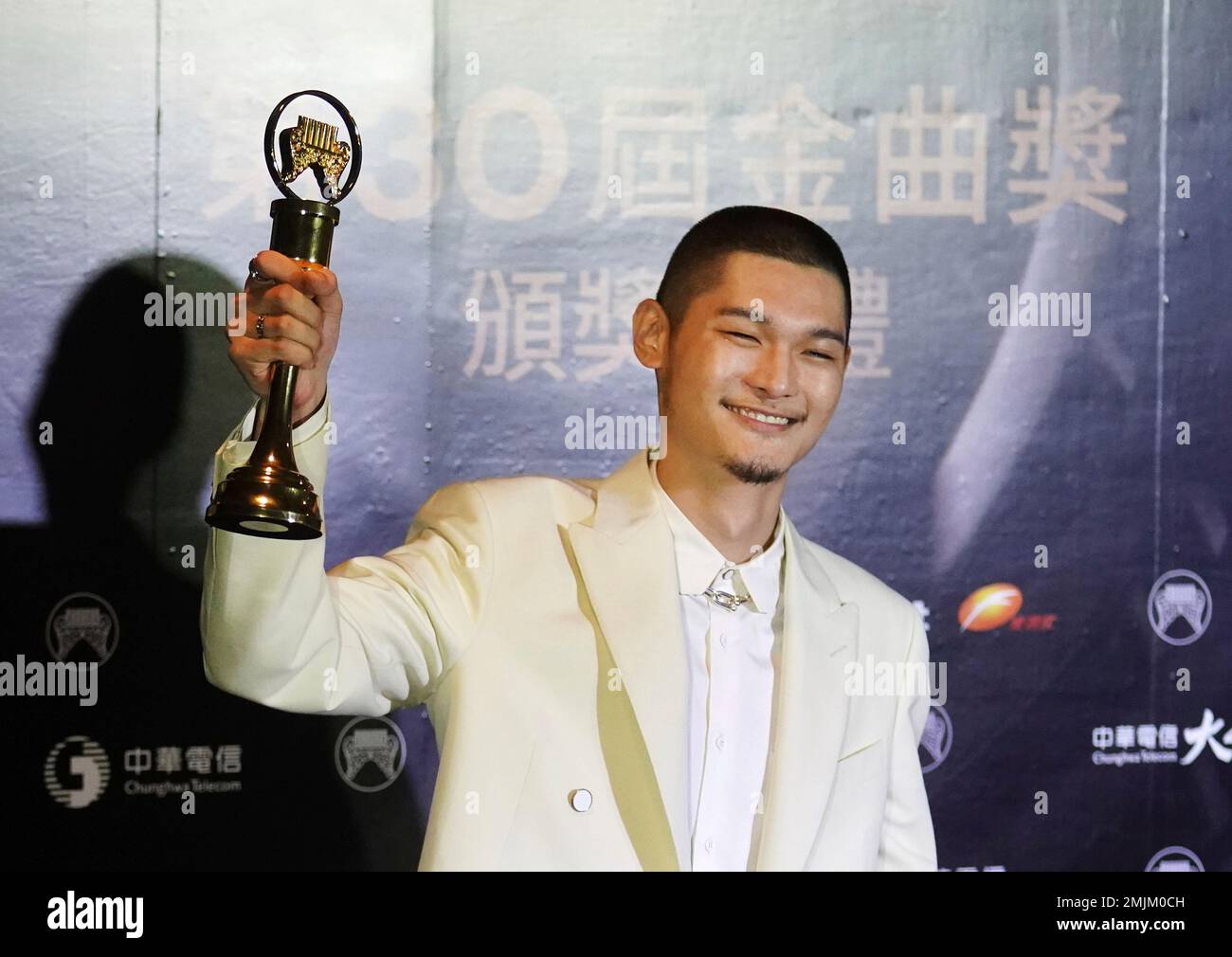 Taiwanese singer Leo Wang holds his award for the Best Male Mandarin ...