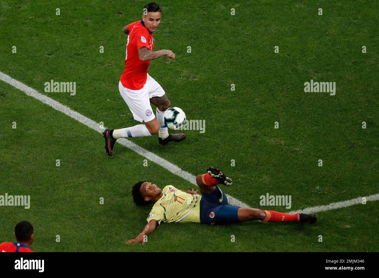 Colombia's Juan Cuadrado, bottom, kicks the ball when falling on the ...